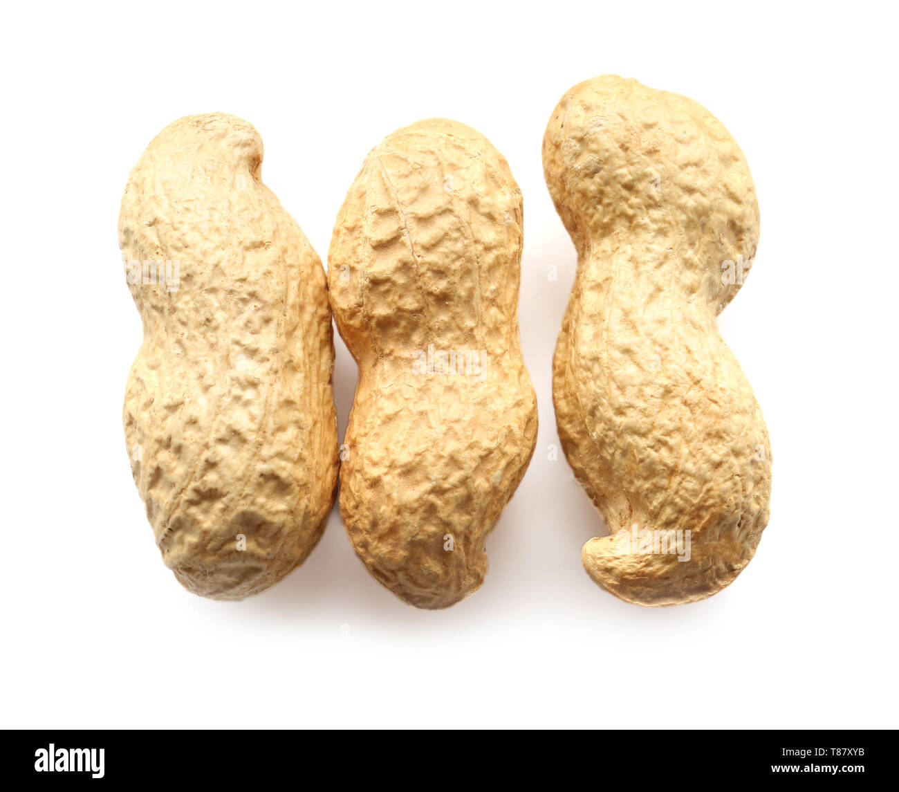 Unpeeled peanuts on white background Stock Photo - Alamy