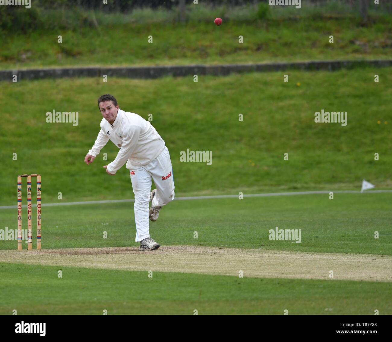Slow bowler in action in the match between Glossop and Moorside Stock ...