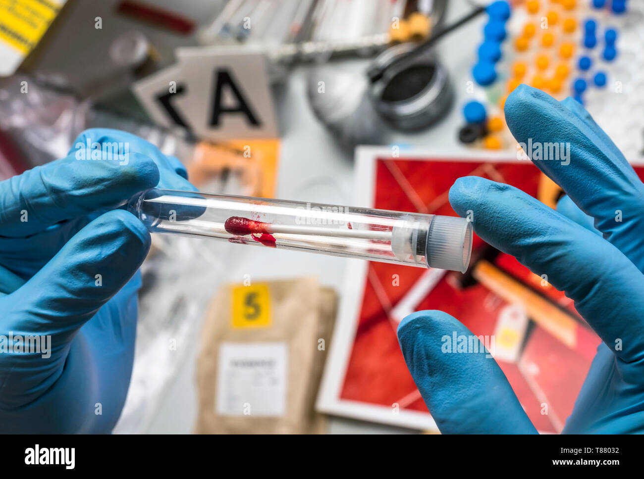 Police expert gets blood sample from glass bottle in Criminalistic Lab ...