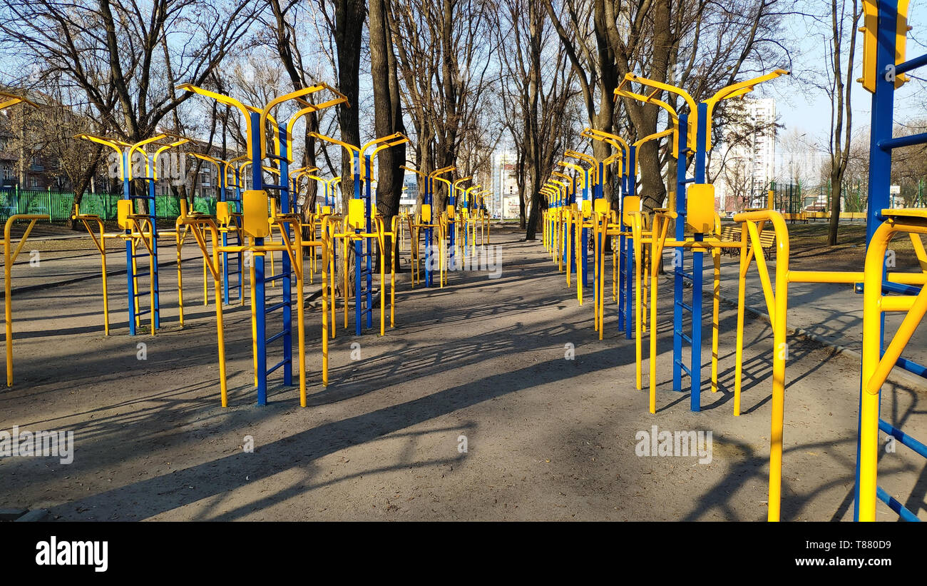 Yellow-blue exercise equipment located on the street for sports ...