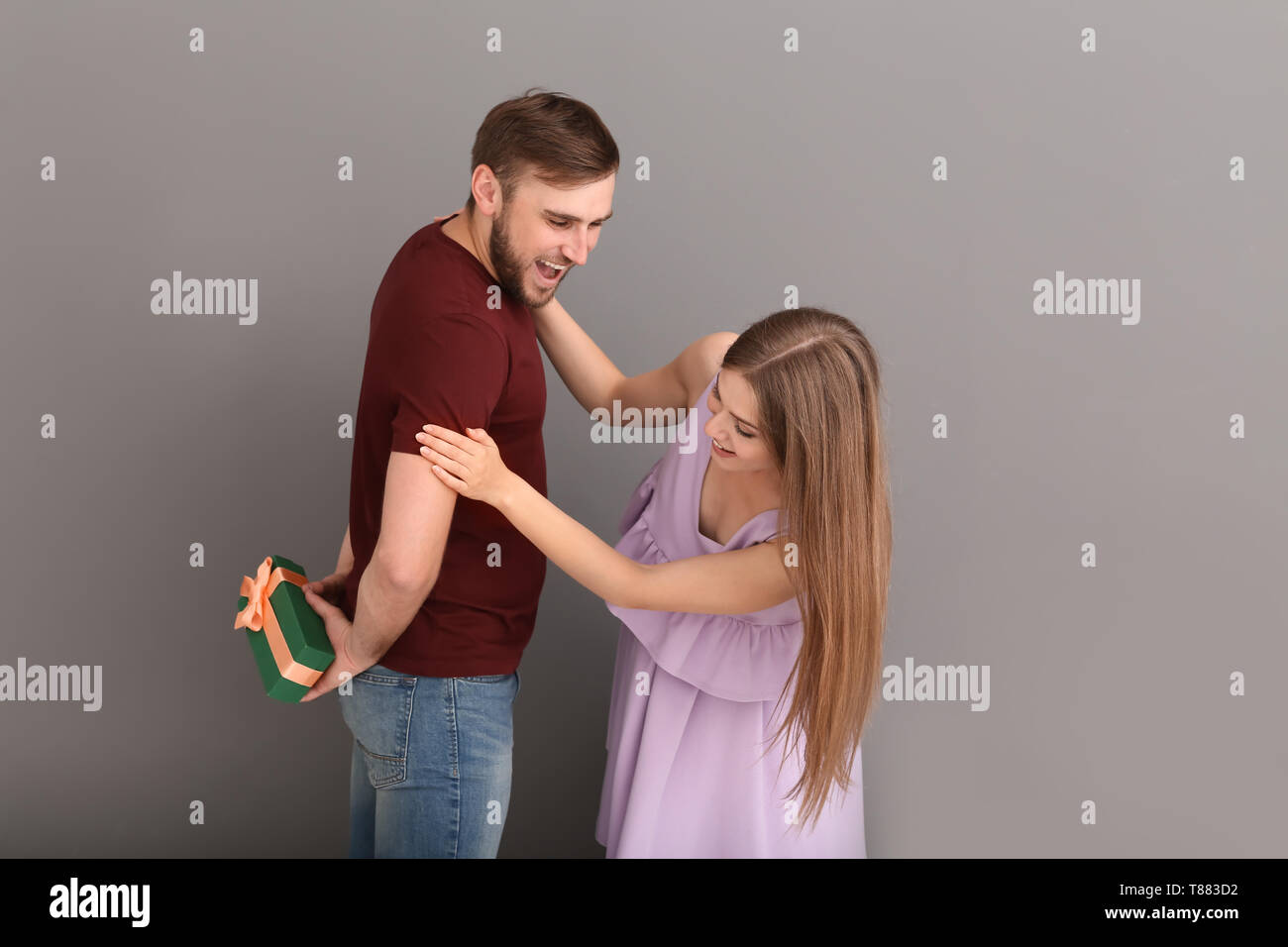 Beautiful woman hide behind back the present box hi-res stock ...