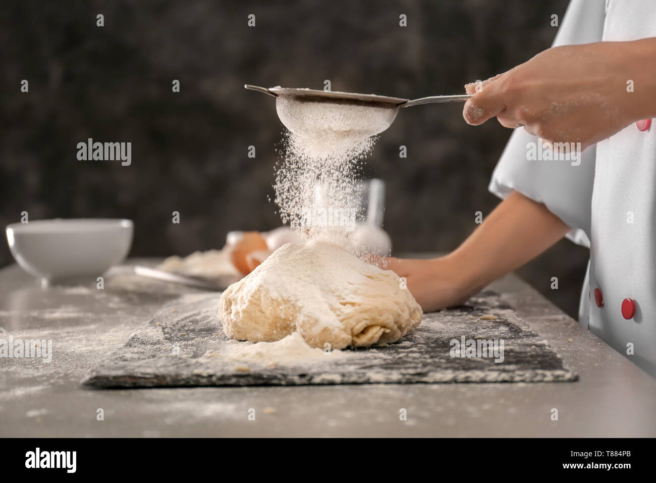 Baker pouring flour knead dough hi-res stock photography and images - Alamy