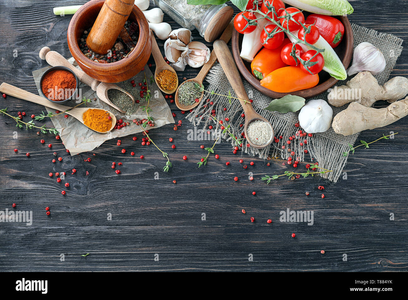 Different kinds of spices with vegetables on wooden background Stock ...