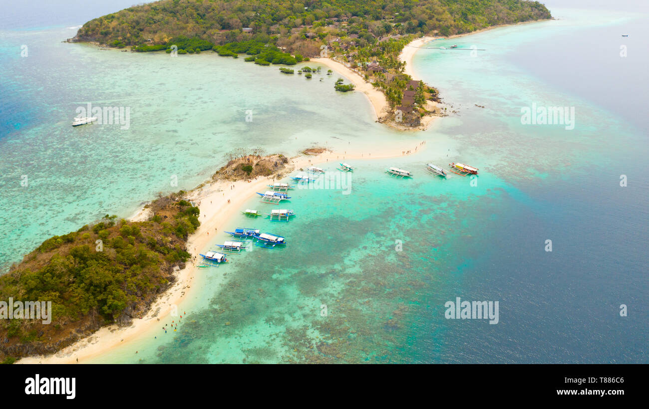 Philippine islands with white beaches. Boats for tourists near the ...