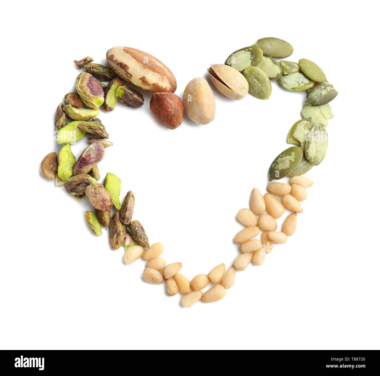Heart made of different nuts on white background Stock Photo - Alamy