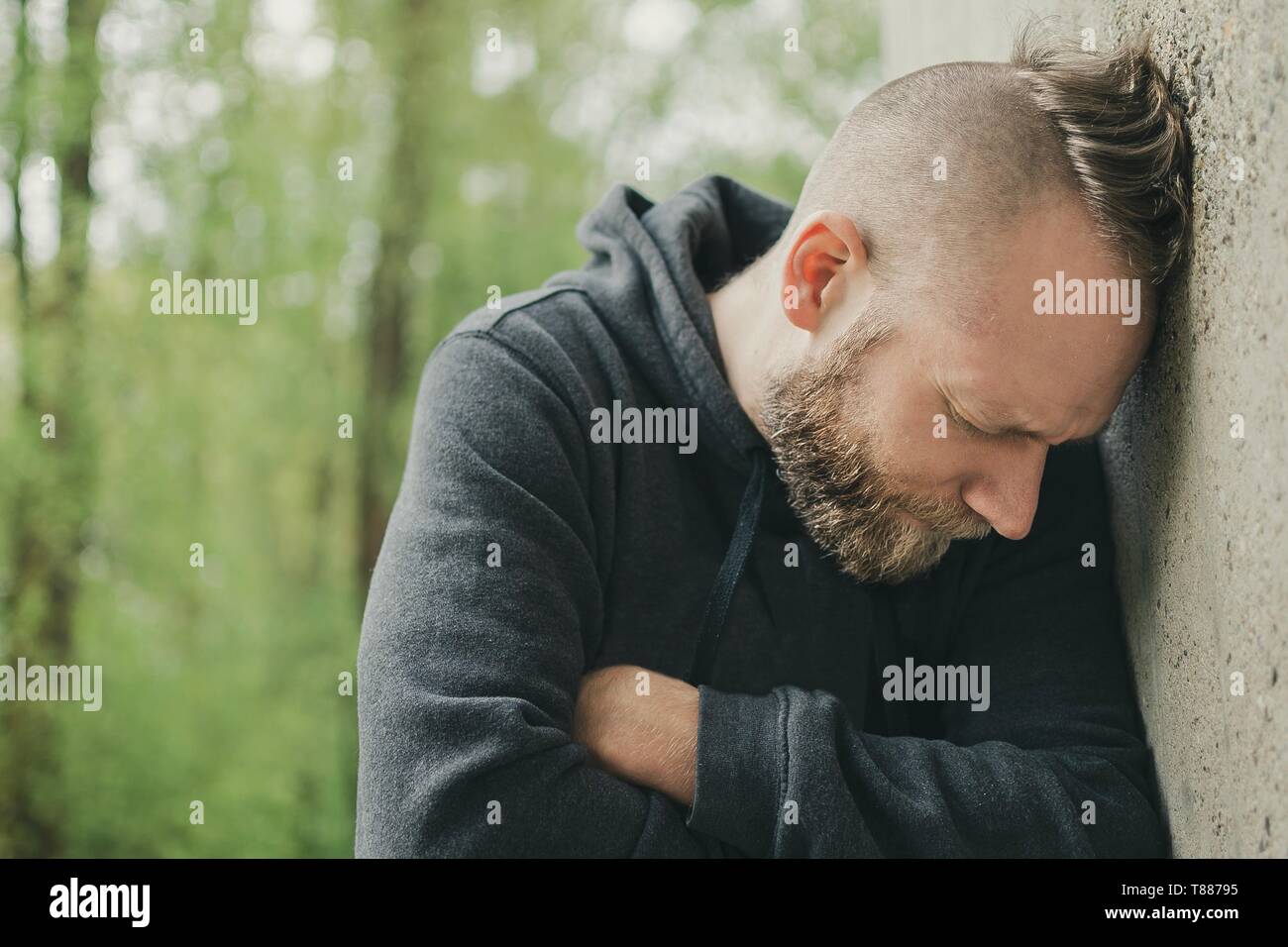 depressed and lonely man his head against a wall Stock Photo - Alamy