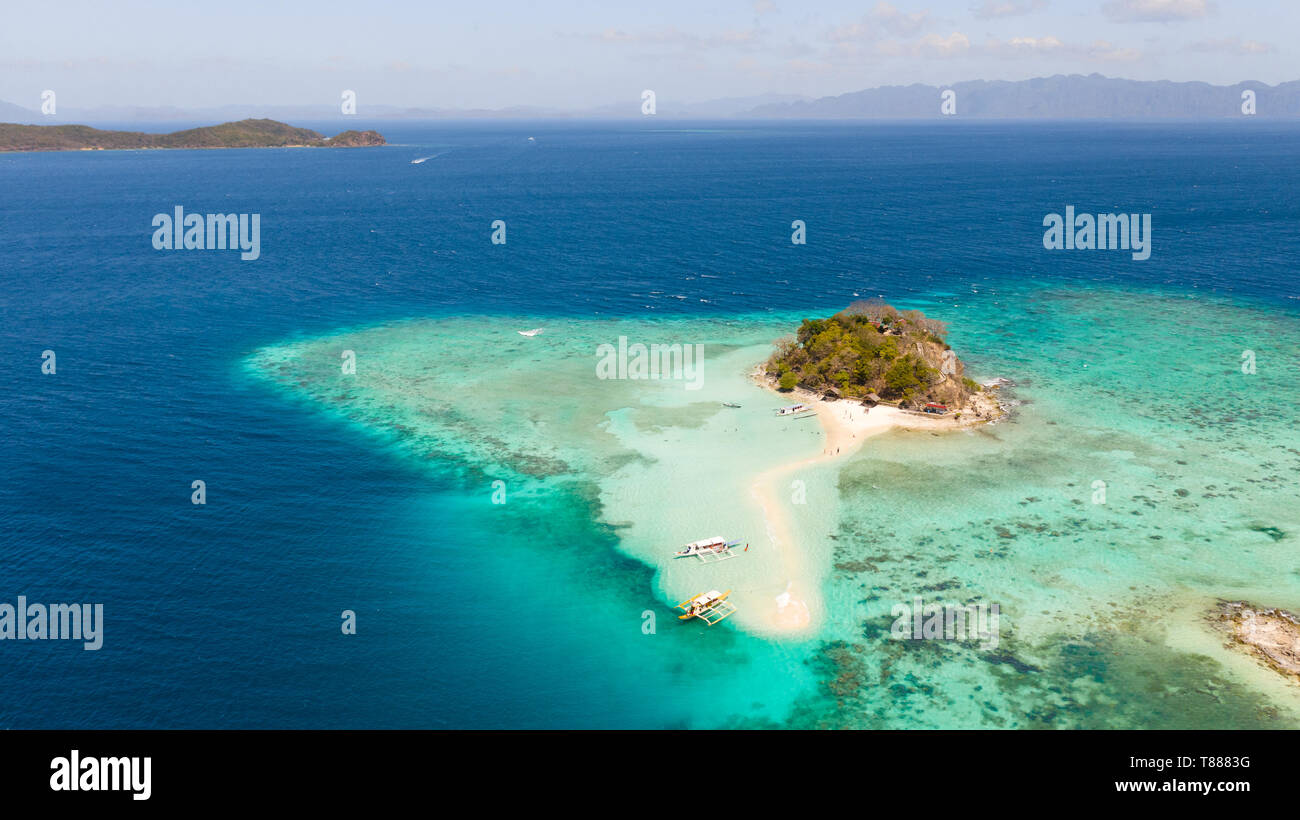 A small island for tourists with a sand bar.Tourists rest on a small ...