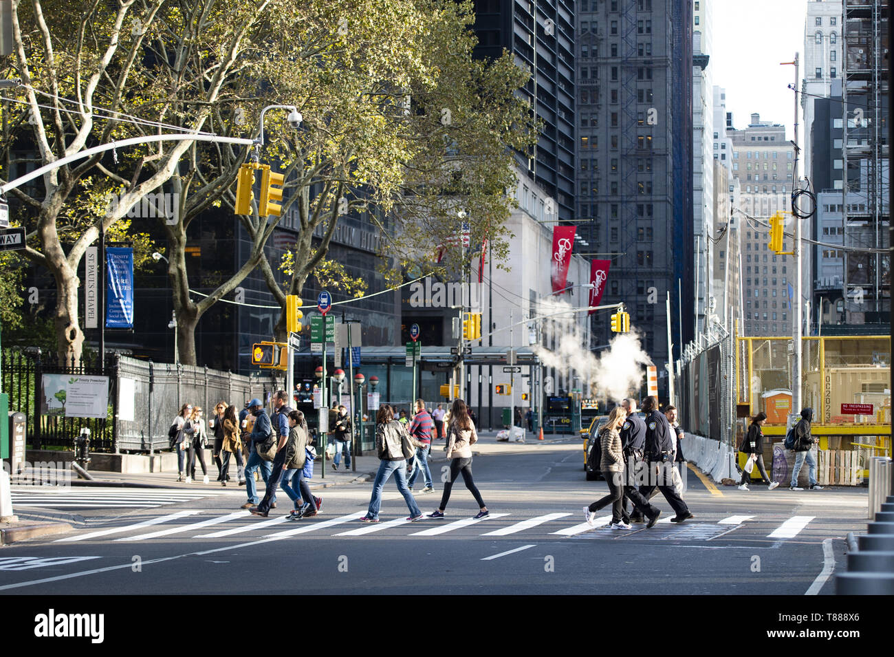 Street traffic on the streets of Manhattan with people crossing a busy ...