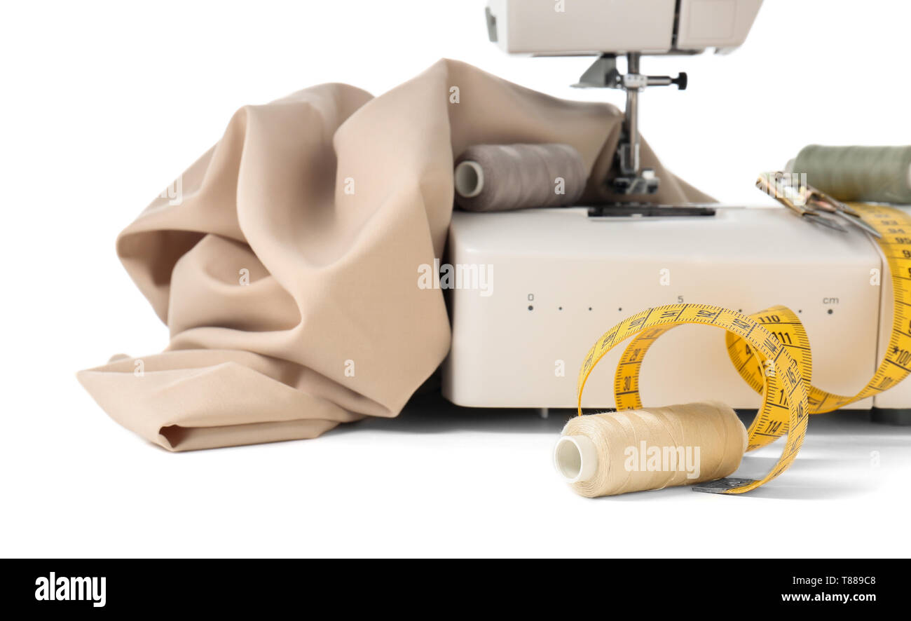 Modern sewing machine with tailor's supplies on white background Stock ...