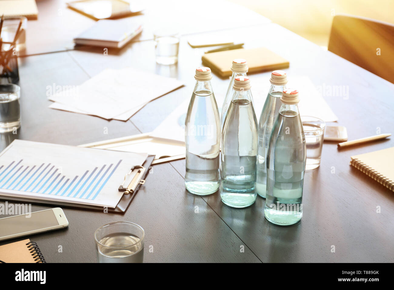Table with bottles of water prepared for business meeting in conference ...