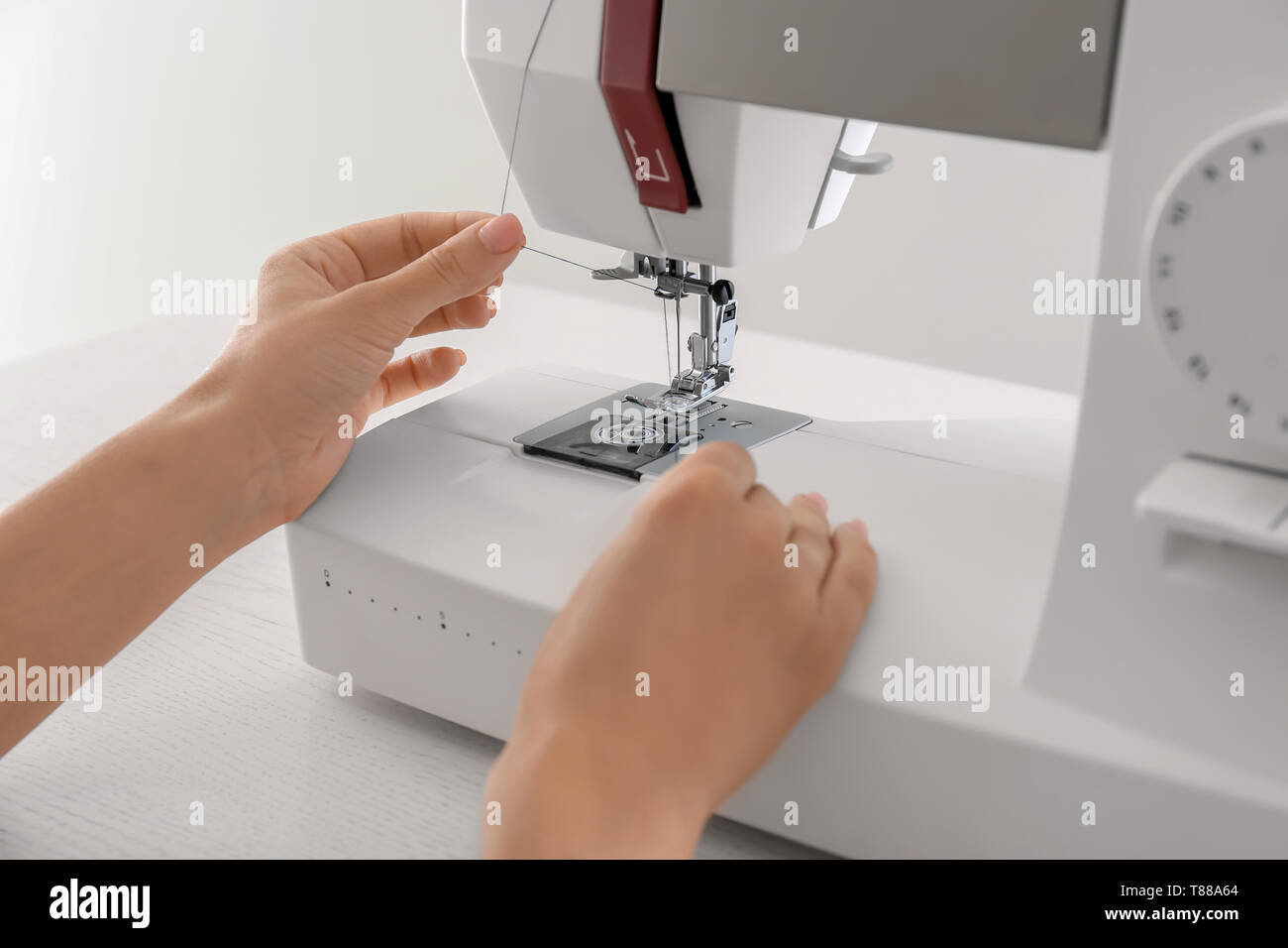 Female tailor threading sewing machine Stock Photo - Alamy
