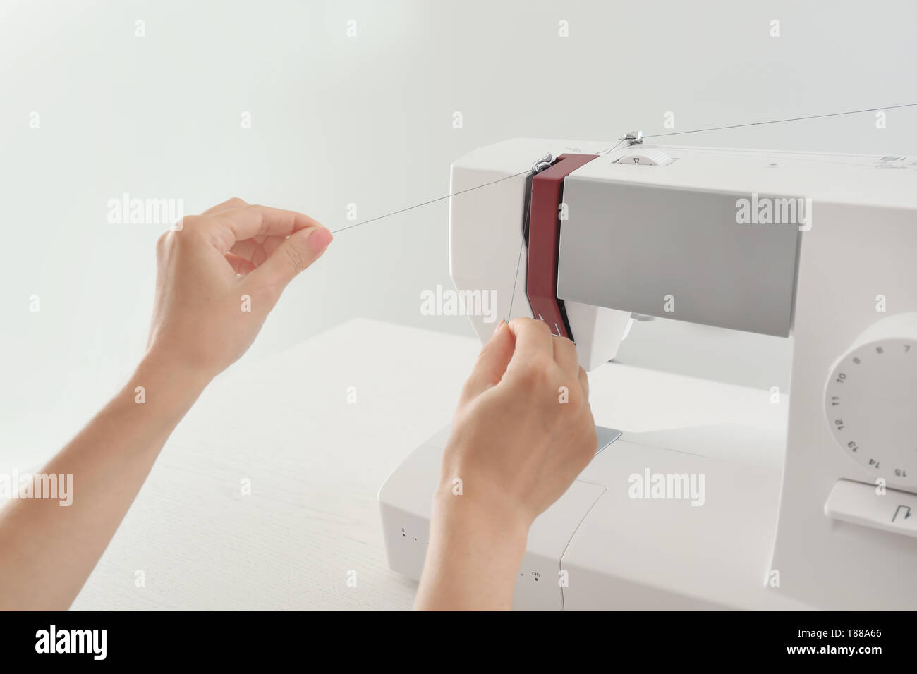 Female tailor threading sewing machine Stock Photo - Alamy