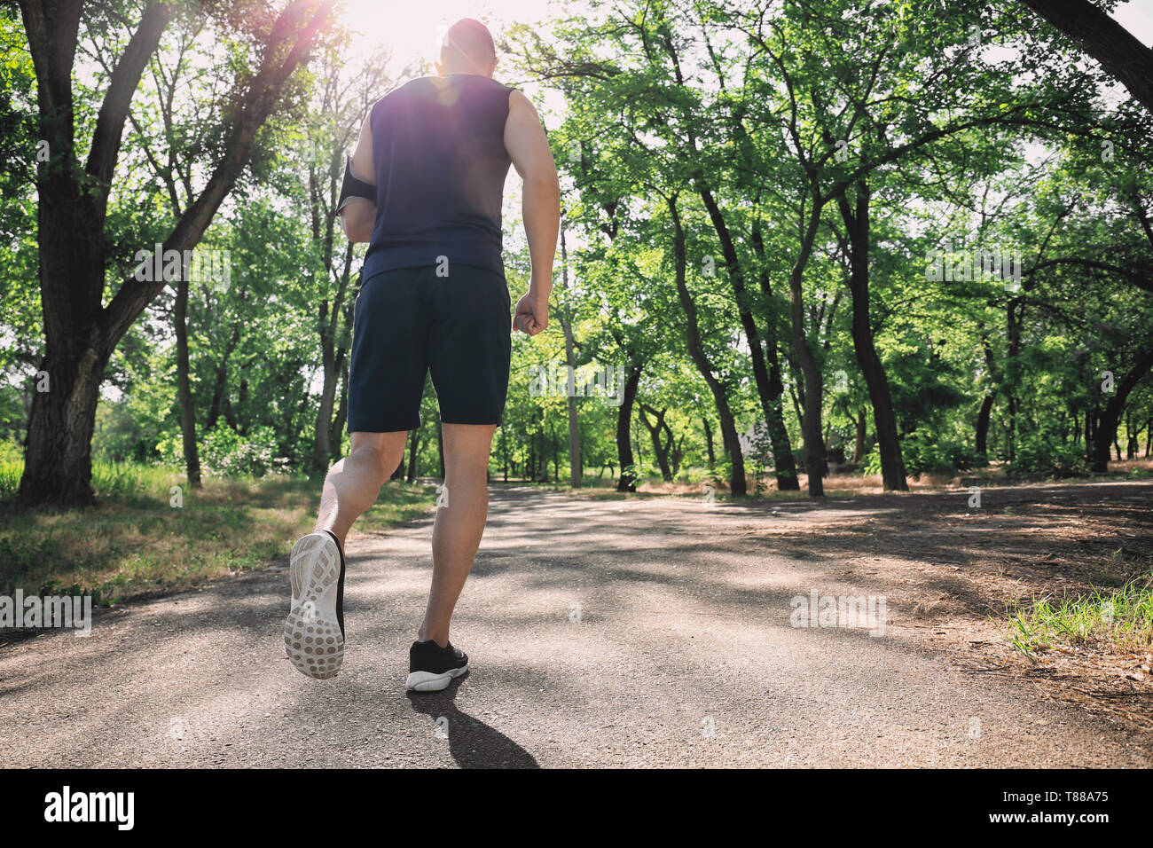 Sporty man running in park Stock Photo - Alamy