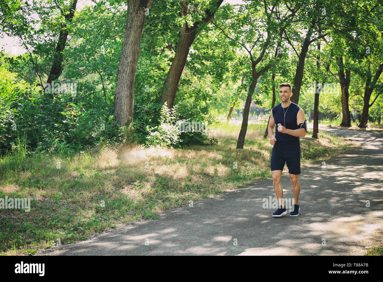Sporty man running in park Stock Photo - Alamy