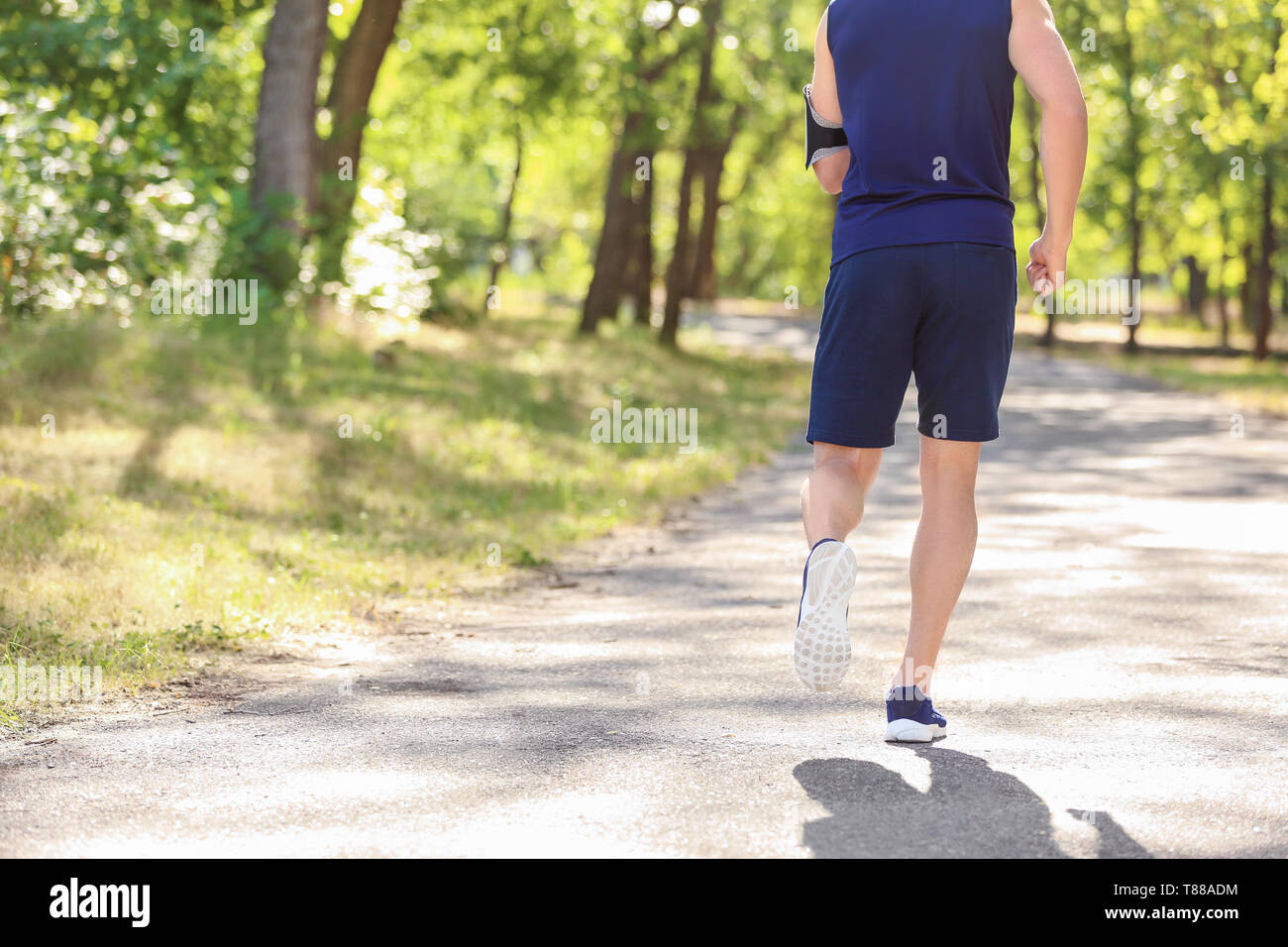 Sporty man running in park hi-res stock photography and images - Alamy