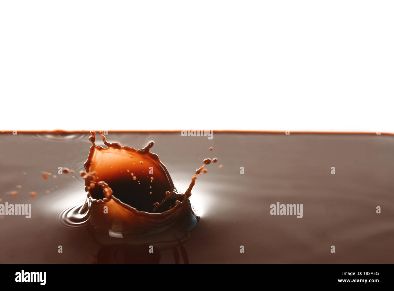 Splash of cocoa on white background Stock Photo - Alamy