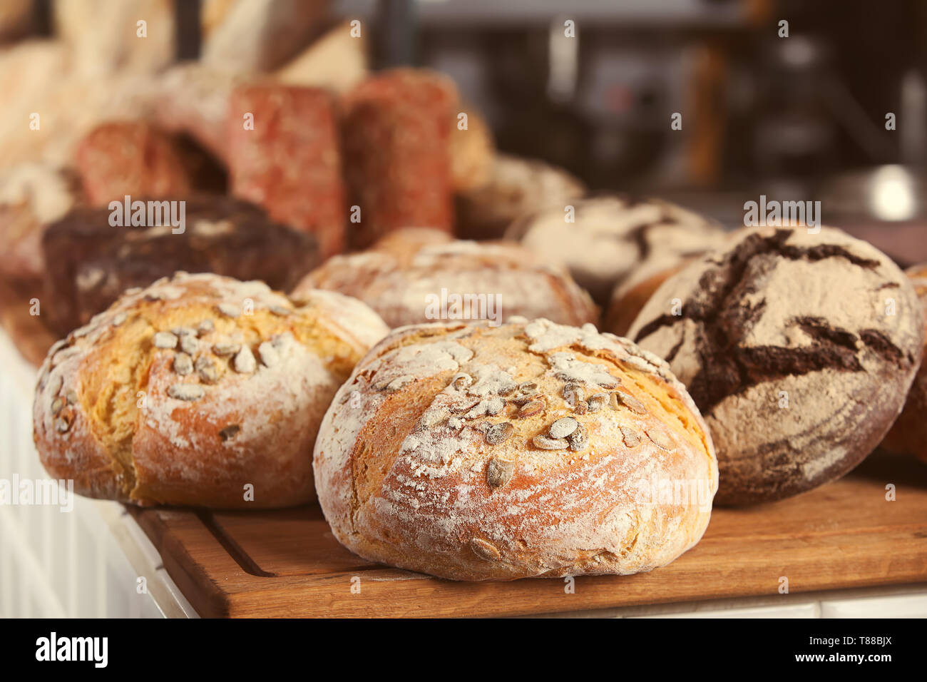 Assortment of fresh bread on counter in bakery Stock Photo - Alamy