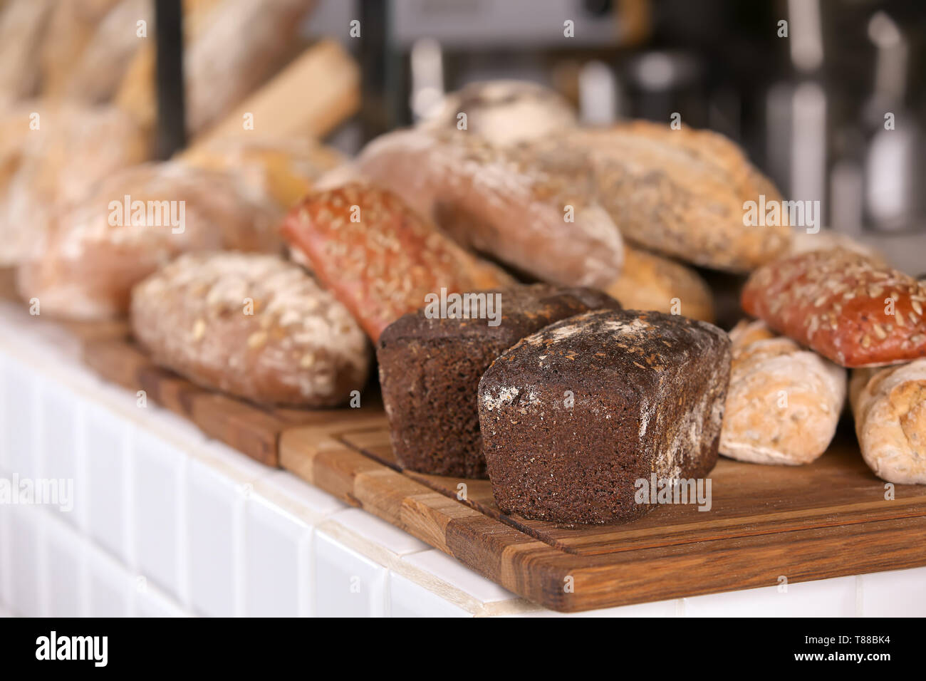 Assortment of fresh bread on counter in bakery Stock Photo - Alamy