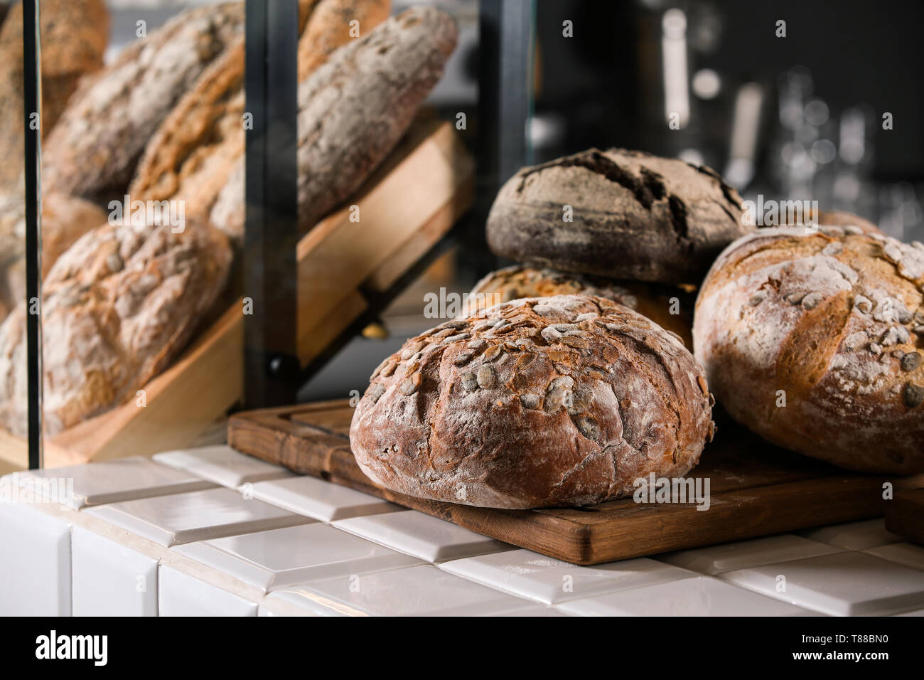 Assortment of fresh bread on counter in bakery Stock Photo - Alamy