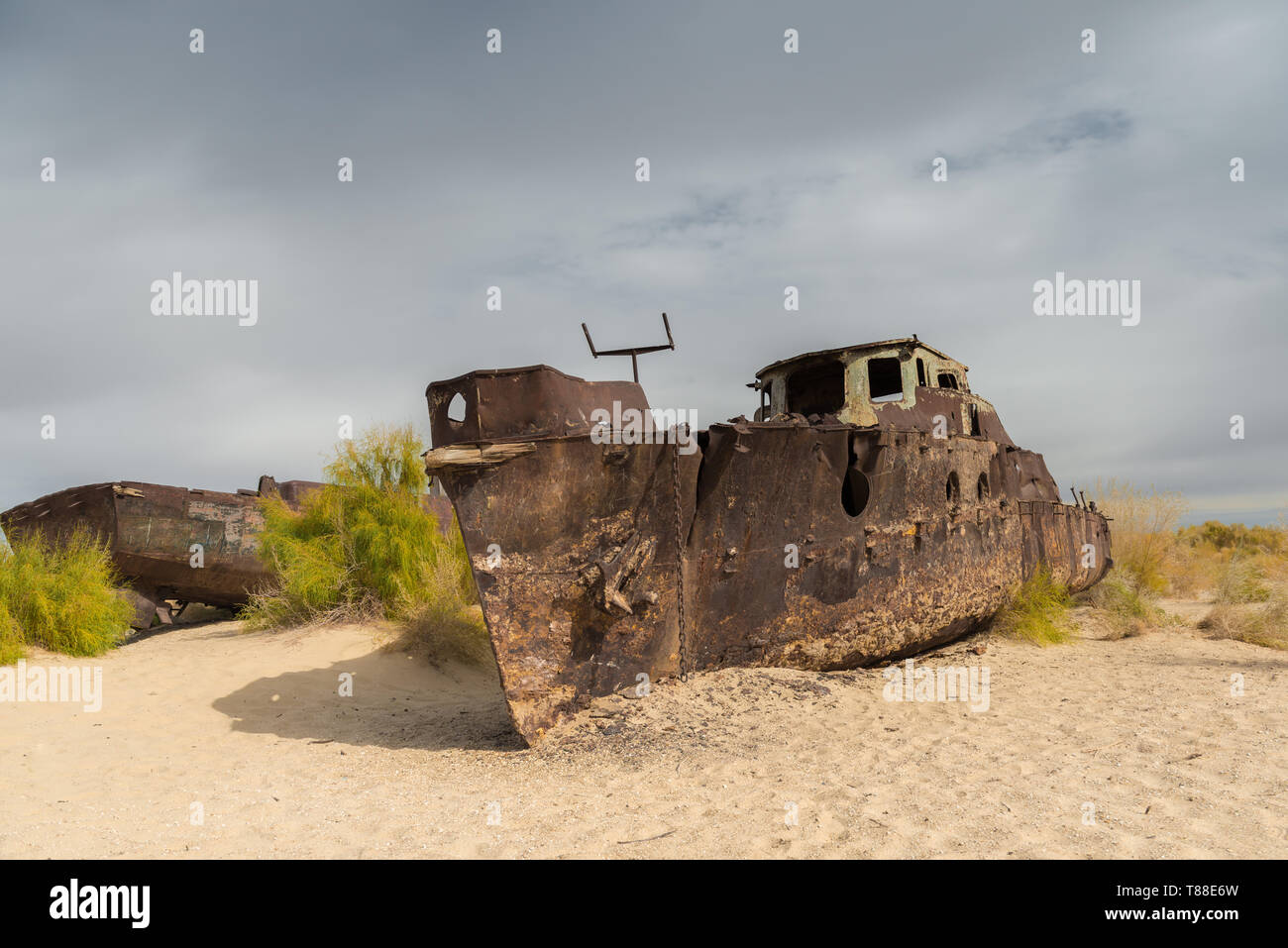 Rusty ships stranded in the sand after the Aral Sea in Uzbekistan has ...