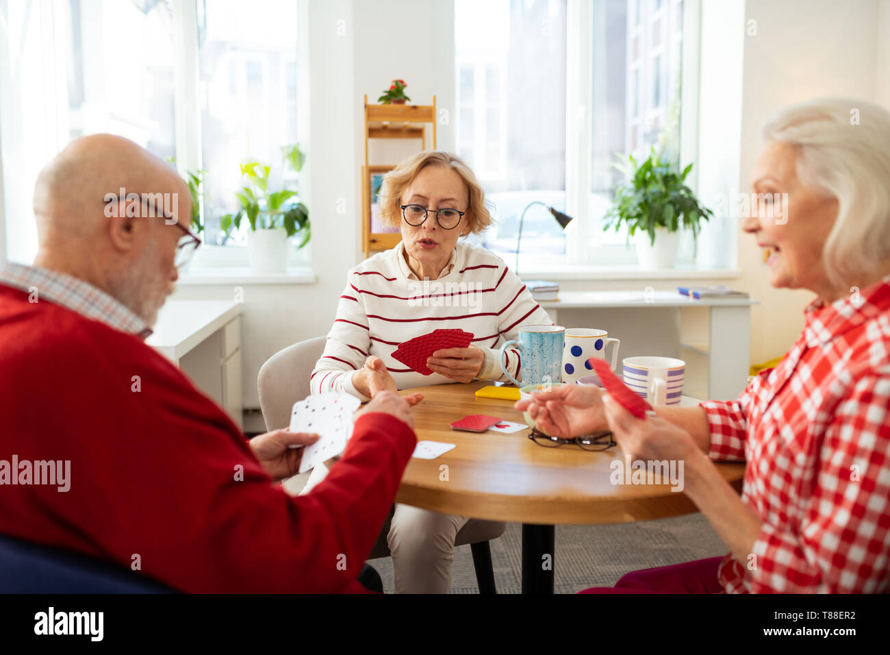 Nice happy aged people talking to each other Stock Photo - Alamy