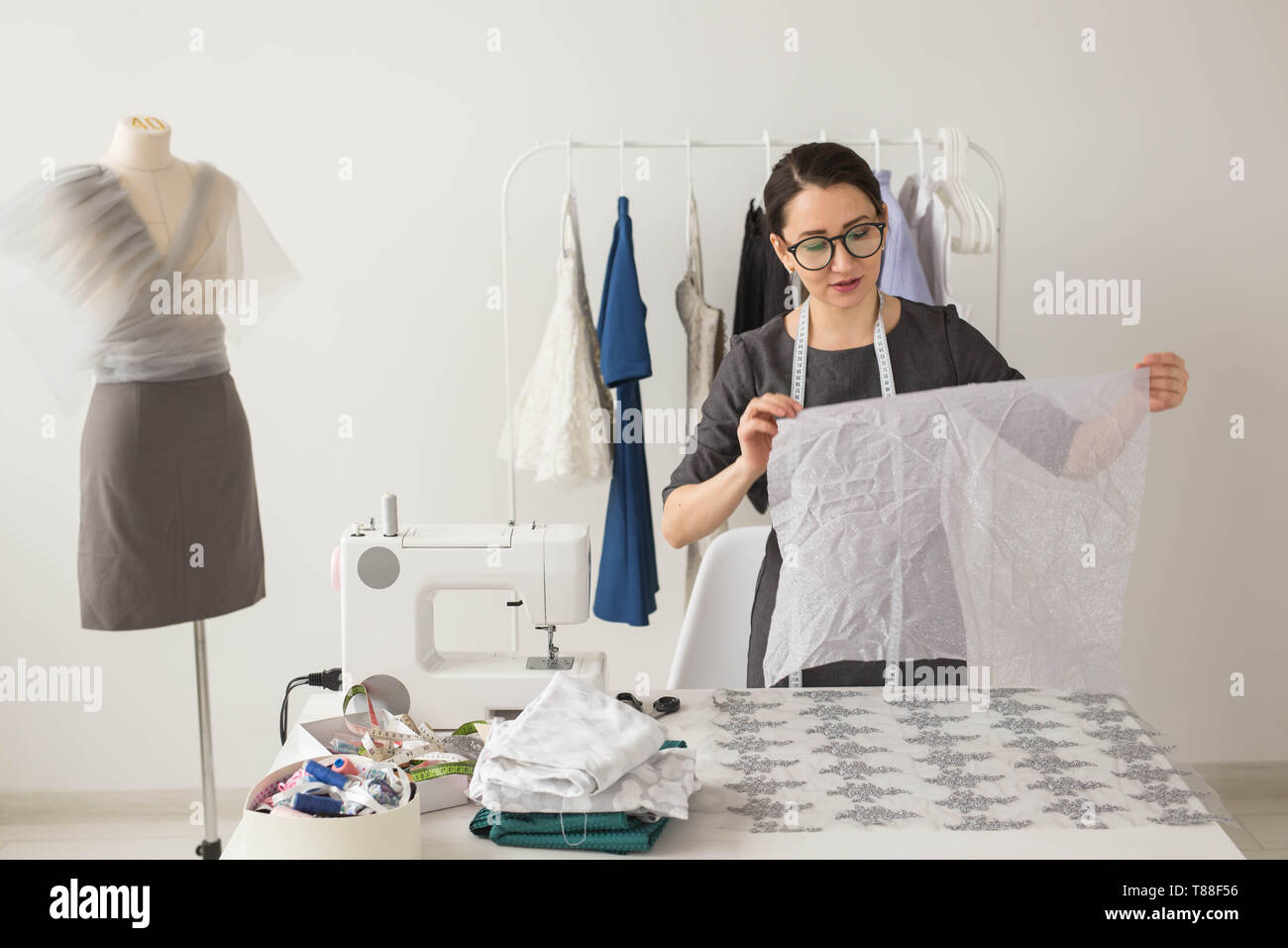 Dressmaker, fashion designer and tailor concept - Young woman designer ...