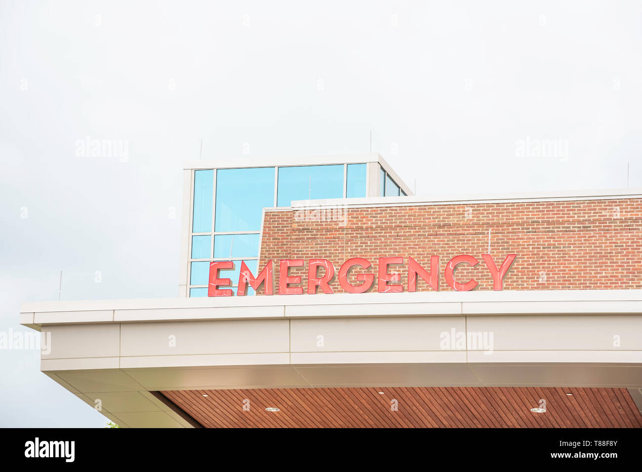 A prominent red 3D all-caps lighted emergency directional sign and ...