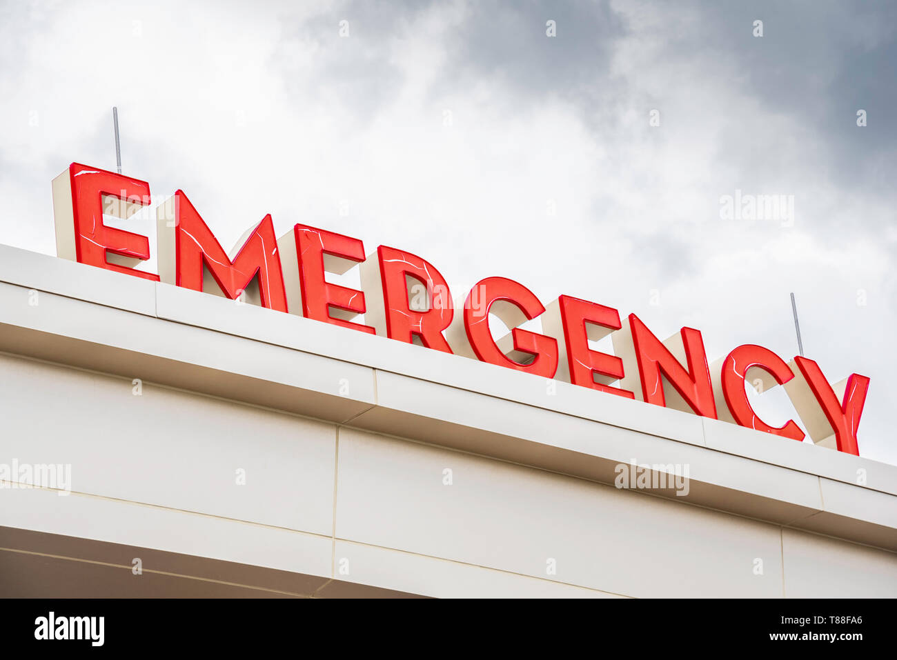 A prominent red 3D all-caps lighted emergency directional sign and ...