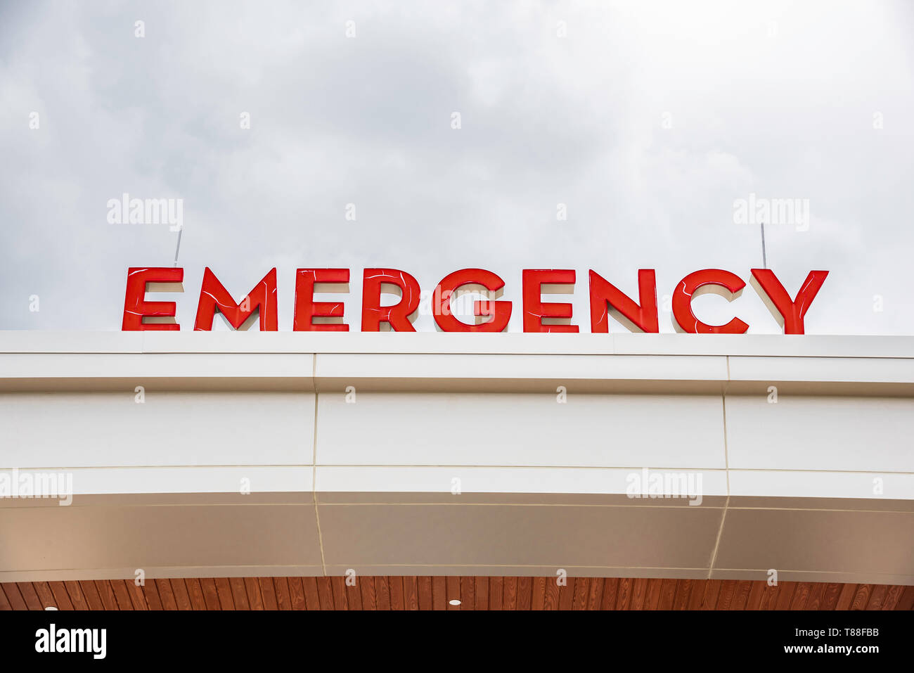 A prominent red 3D all-caps lighted emergency directional sign and ...