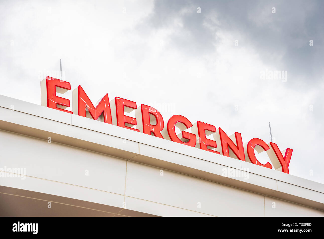 A prominent red 3D all-caps lighted emergency directional sign and ...