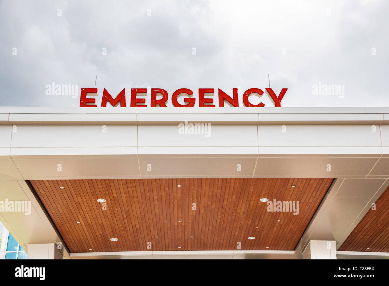 A prominent red 3D all-caps lighted emergency directional sign and ...