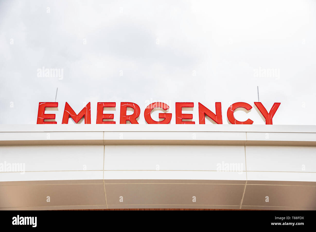 A prominent red 3D all-caps lighted emergency directional sign and ...