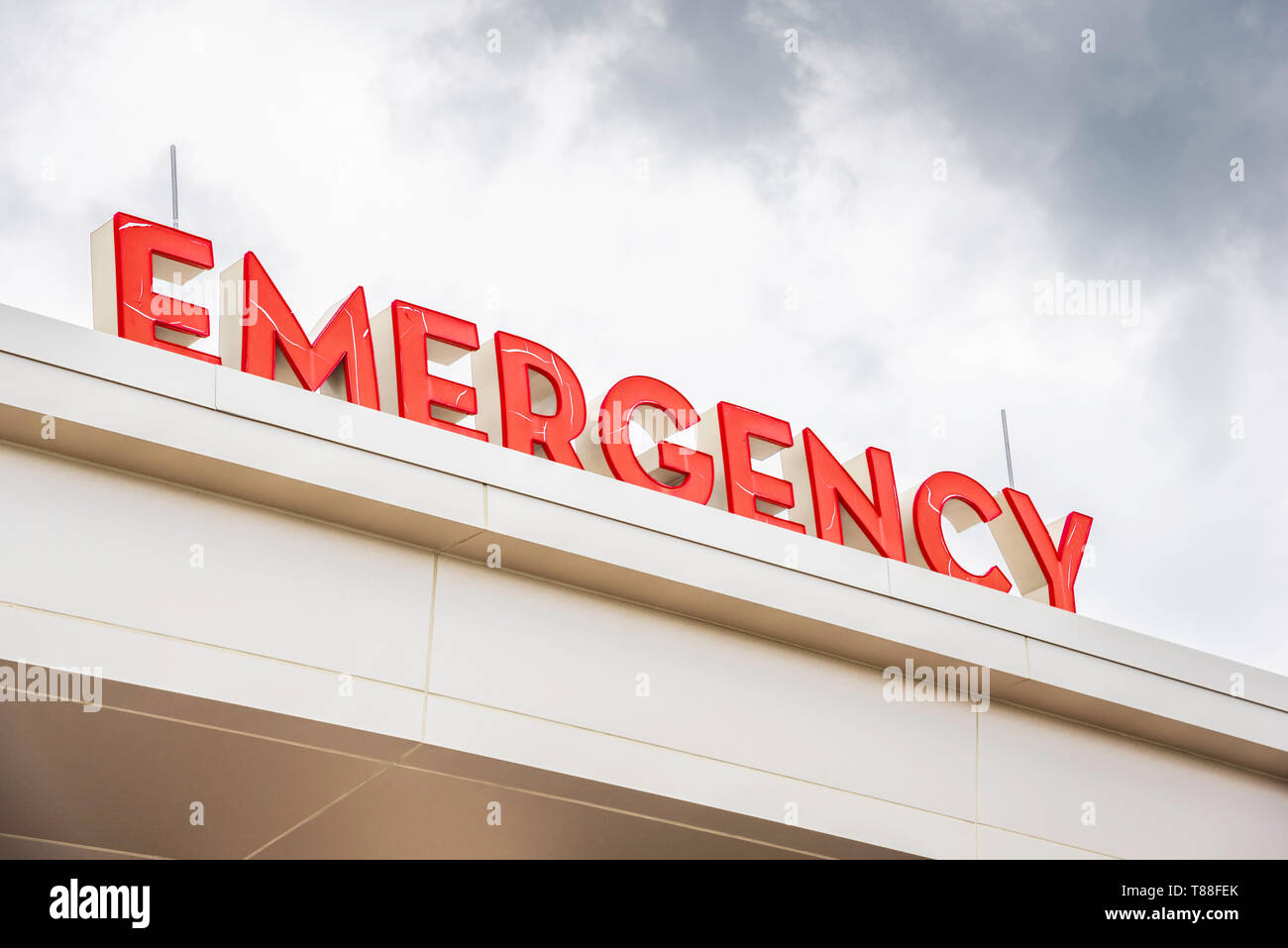 A prominent red 3D all-caps lighted emergency directional sign and ...