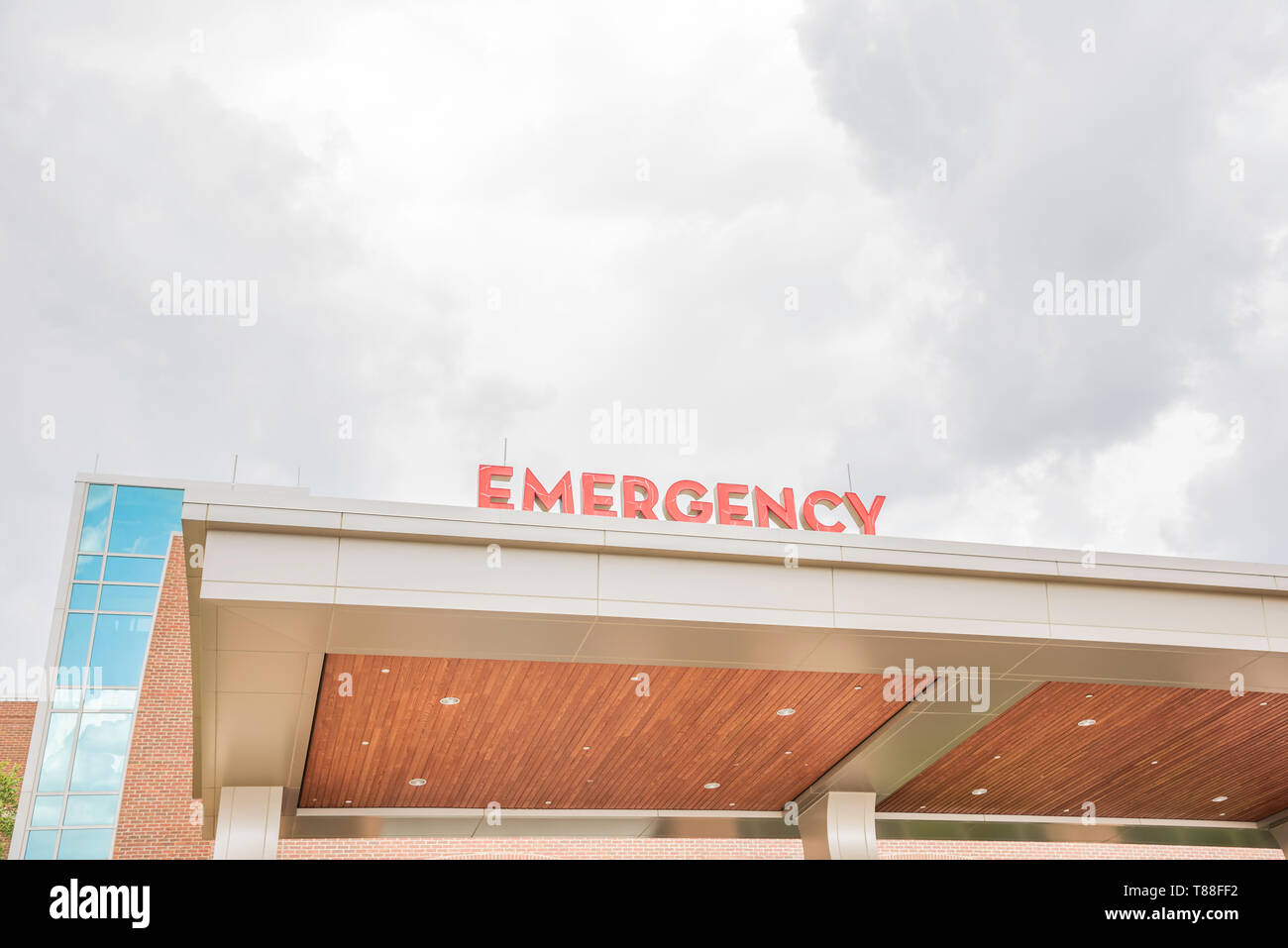 A prominent red 3D all-caps lighted emergency directional sign and ...
