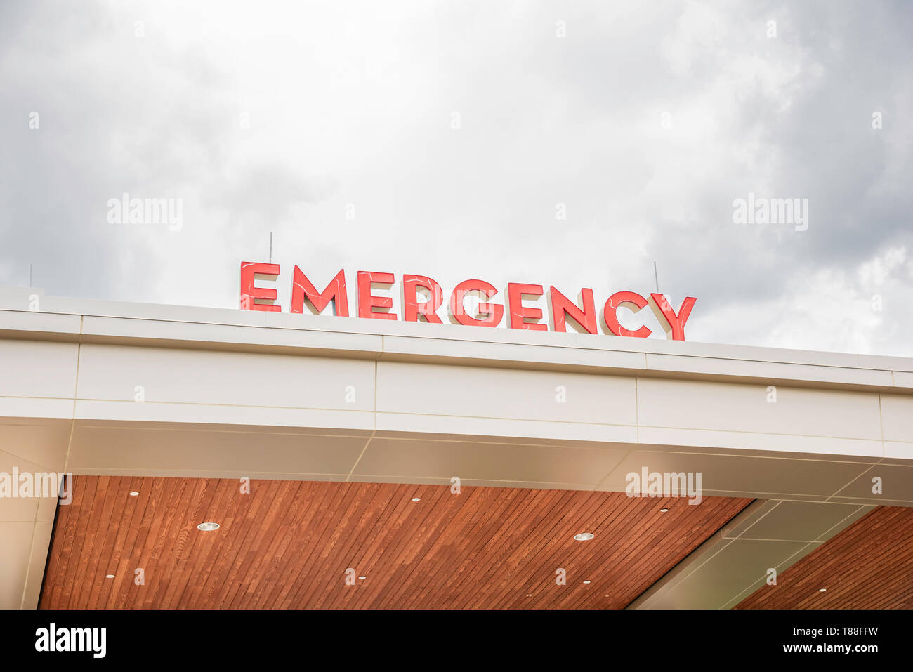 A prominent red 3D all-caps lighted emergency directional sign and ...