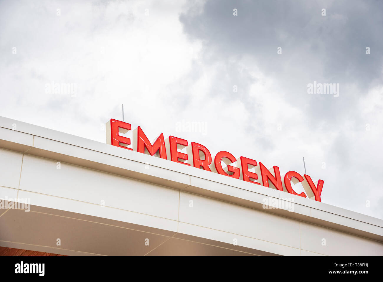 A prominent red 3D all-caps lighted emergency directional sign and ...