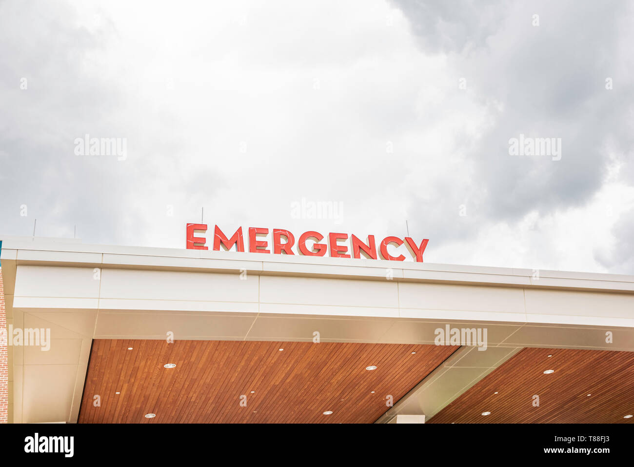 A prominent red 3D all-caps lighted emergency directional sign and ...