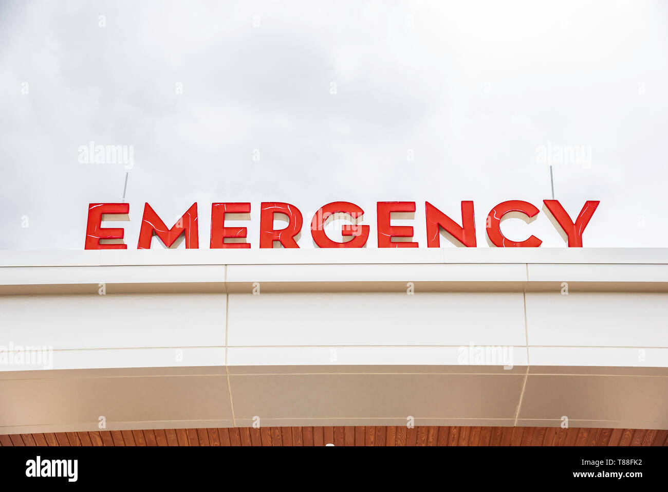 A prominent red 3D all-caps lighted emergency directional sign and ...