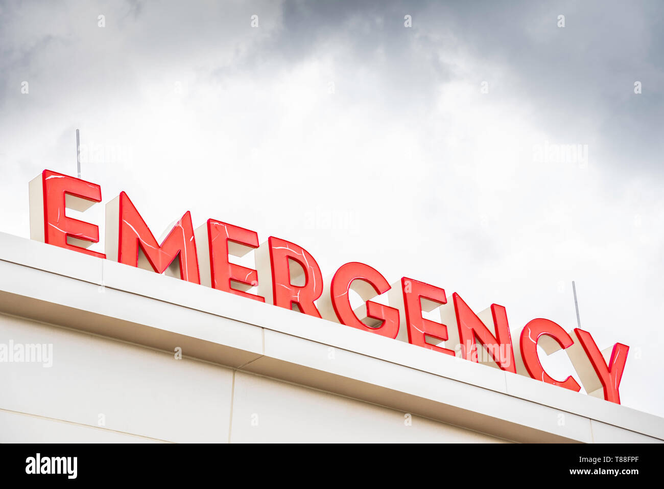 A prominent red 3D all-caps lighted emergency directional sign and ...
