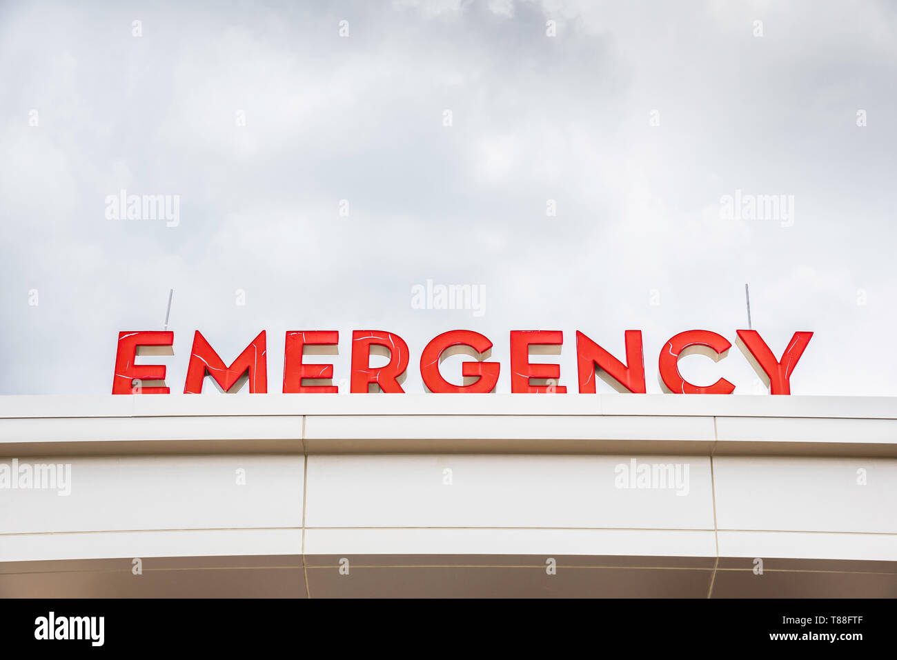 A prominent red 3D all-caps lighted emergency directional sign and ...