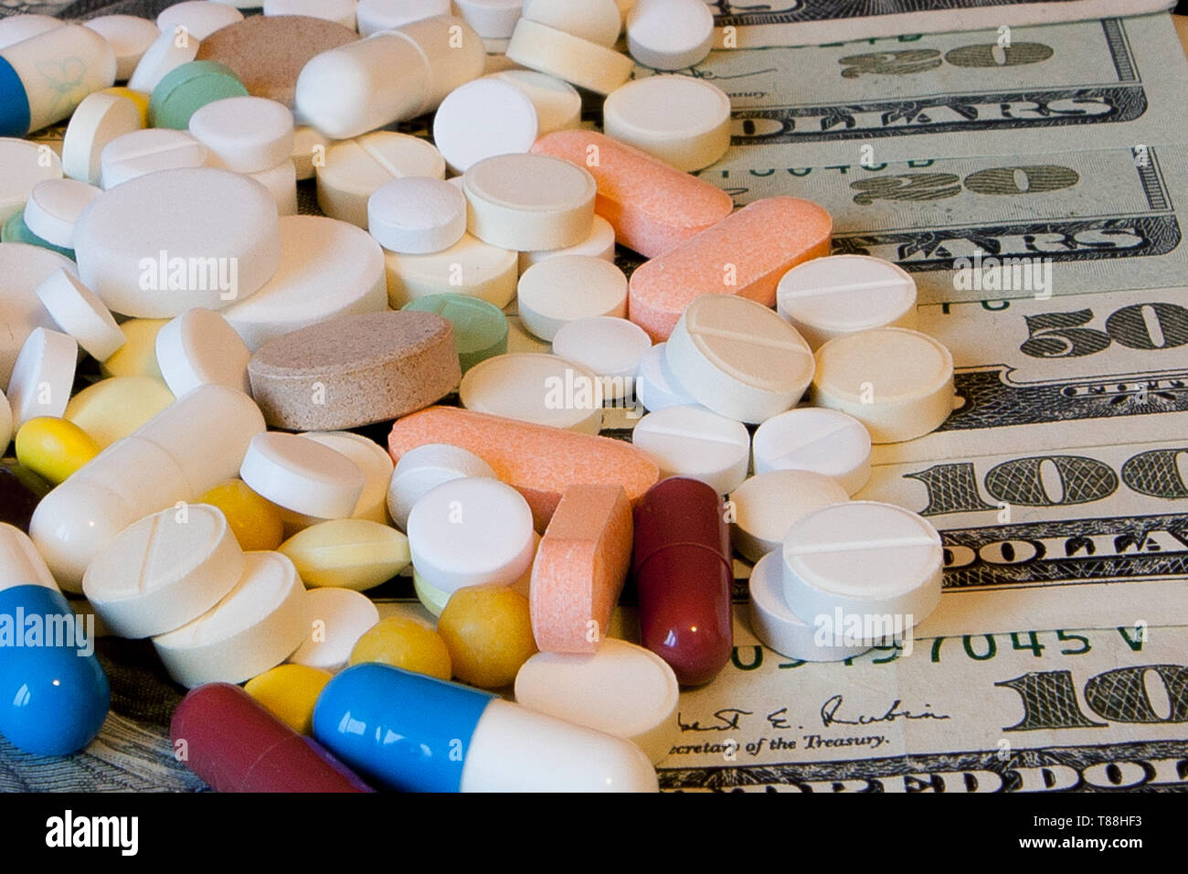 Pills on dollar money isolated on black background. Medicine expenses ...