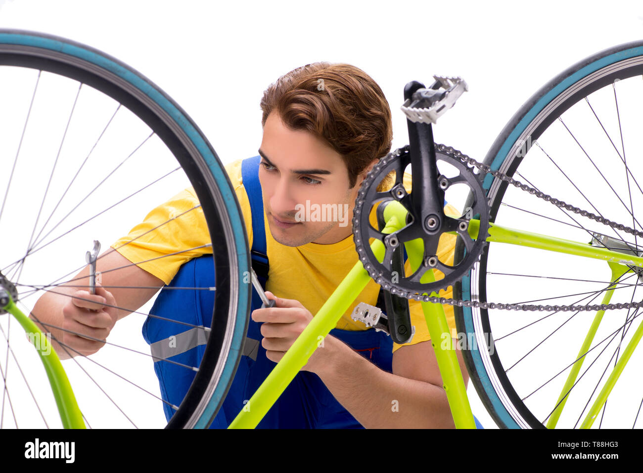 Man repairing his bike isolated on white background Stock Photo - Alamy