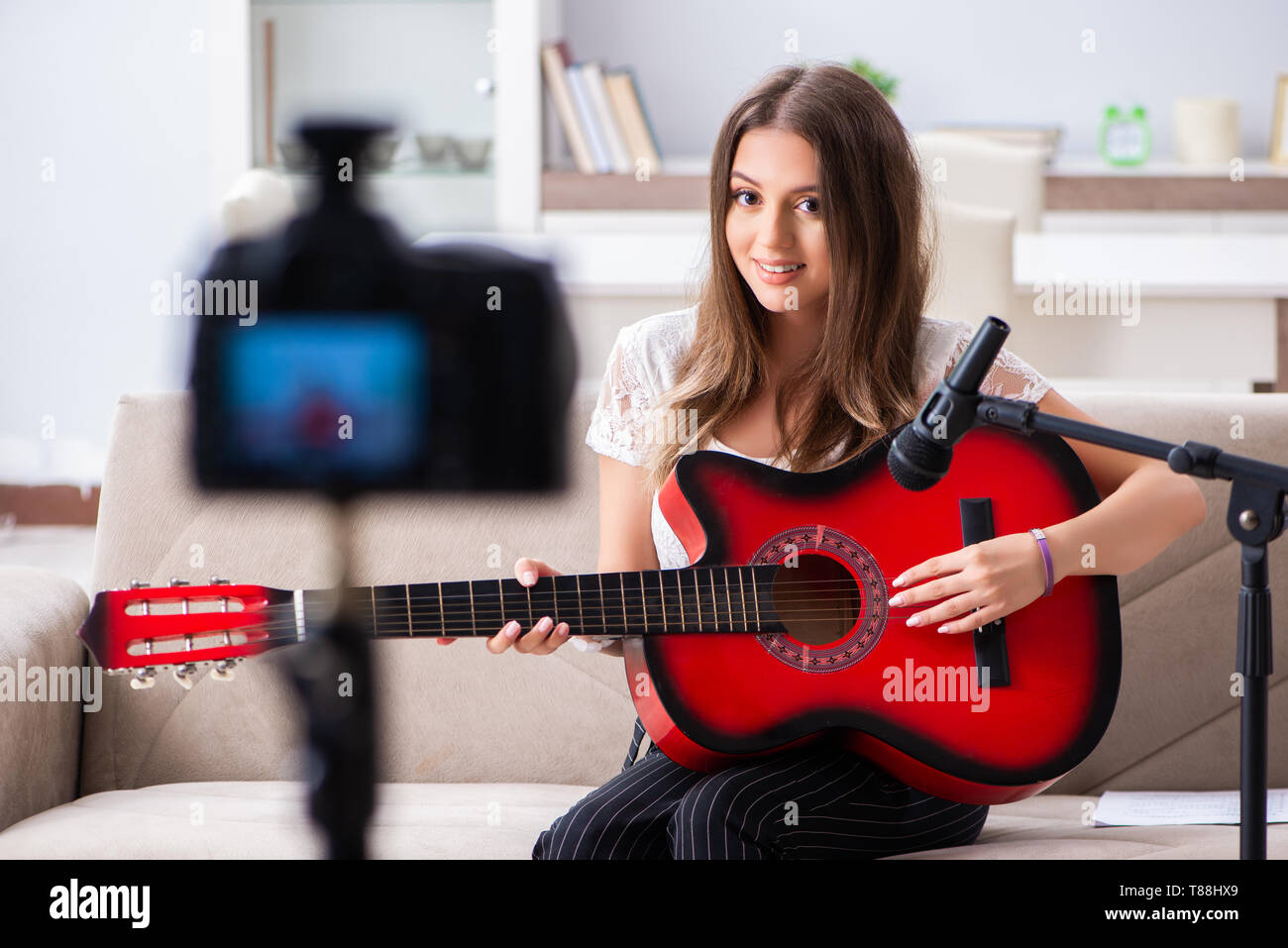 Female beautiful blogger playing guitar Stock Photo - Alamy