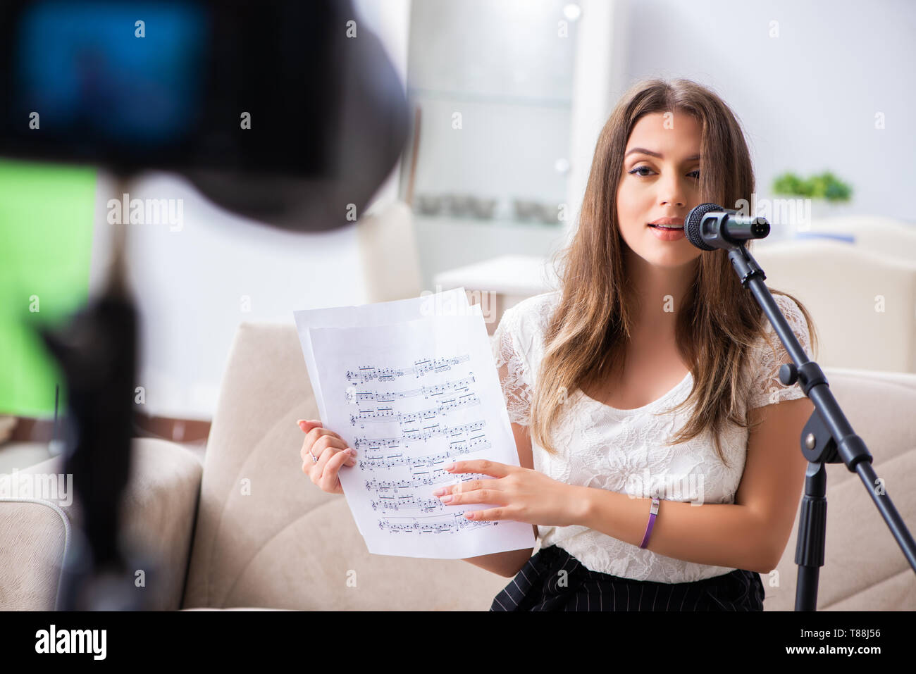 Female beautiful blogger singing at home Stock Photo - Alamy