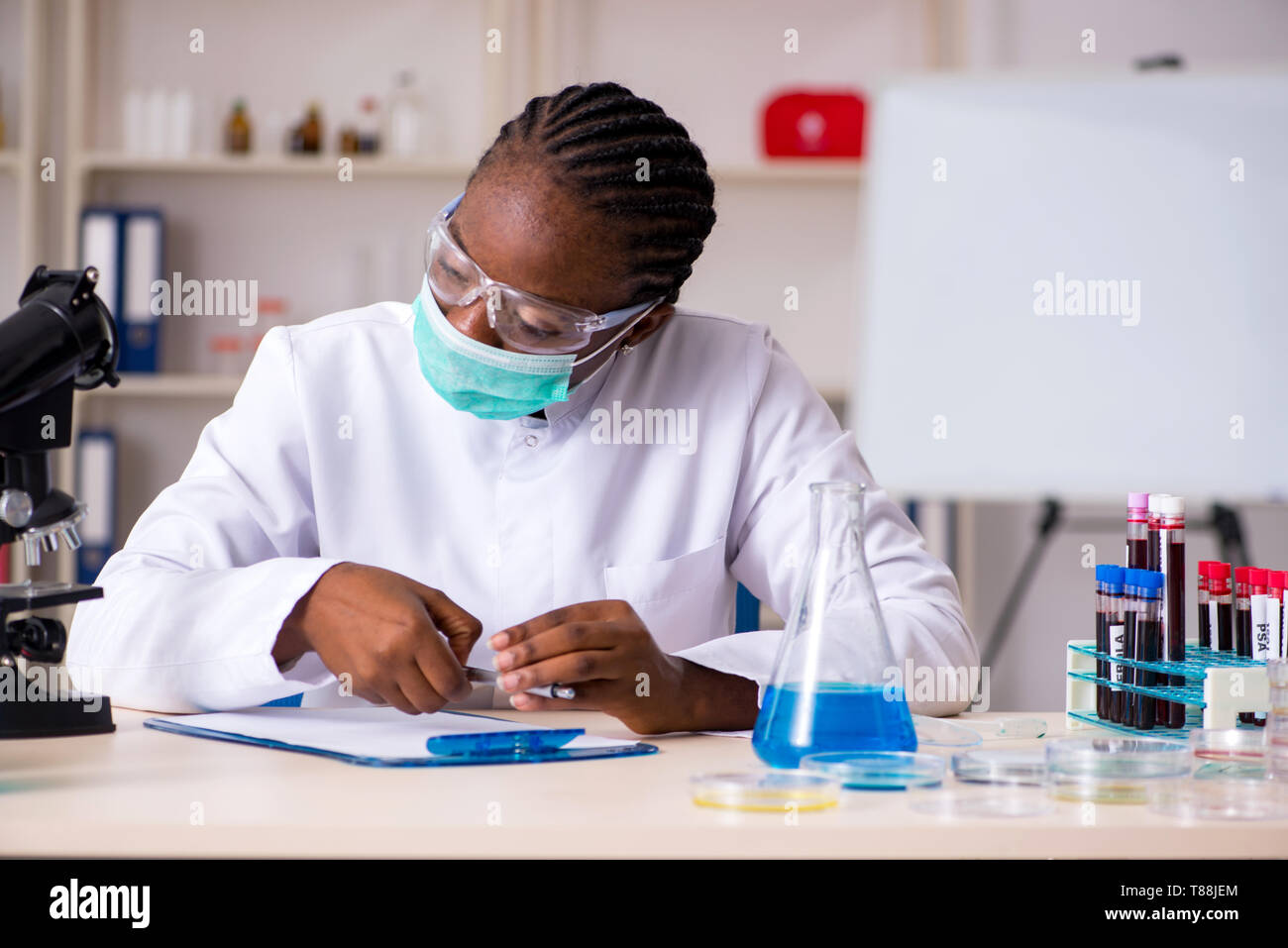 Young black chemist working in the lab Stock Photo - Alamy