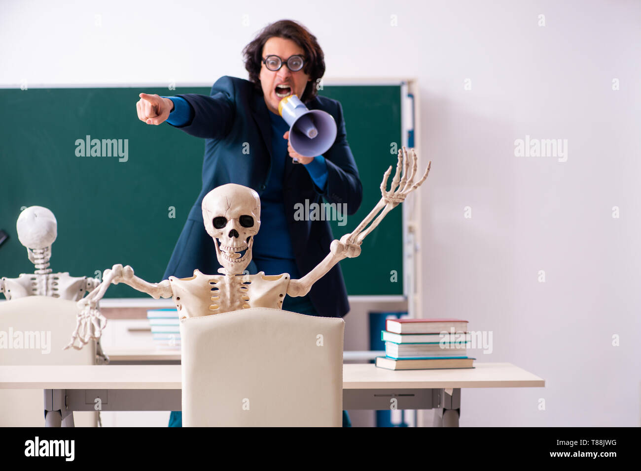 Male teacher and skeleton student in the classroom Stock Photo - Alamy