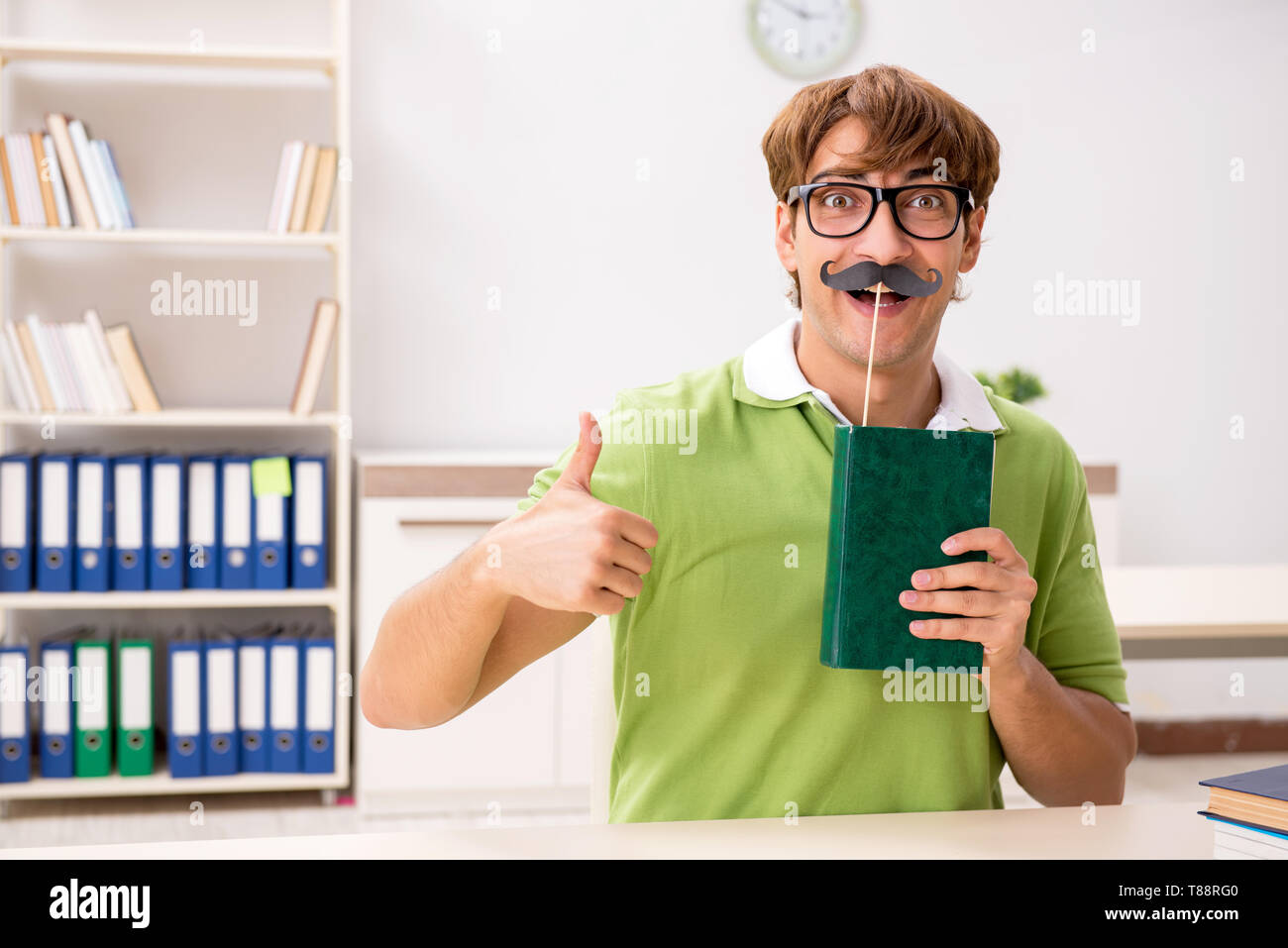 Student with fake moustache reading book Stock Photo - Alamy