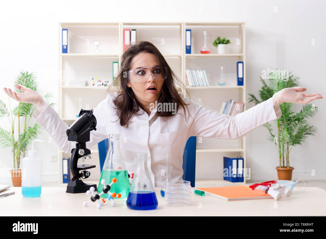 Funny female chemist working in the lab Stock Photo - Alamy