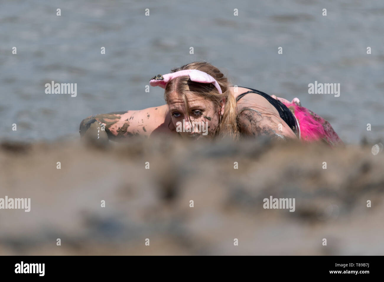 Woman crawling through mud hi-res stock photography and images - Alamy