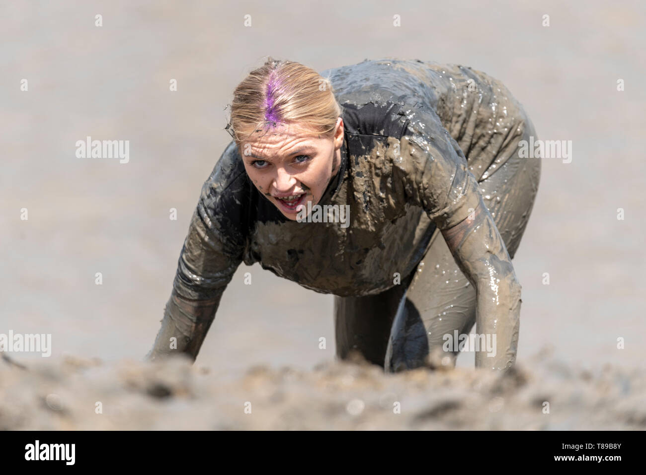 Woman crawling through mud hi-res stock photography and images - Alamy